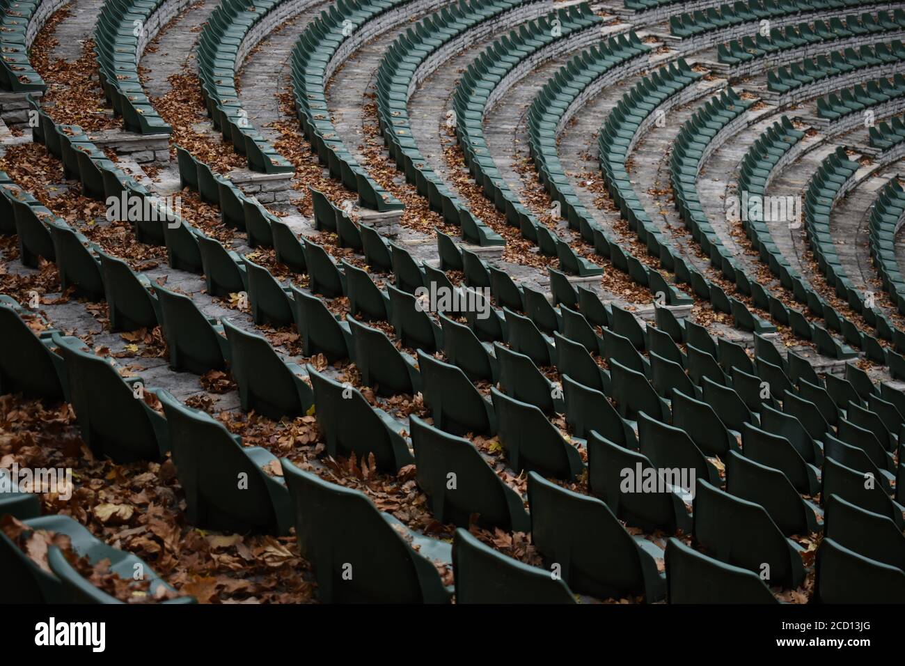 High angle shot of the empty chairs of a big abandoned outdoor stadium ...