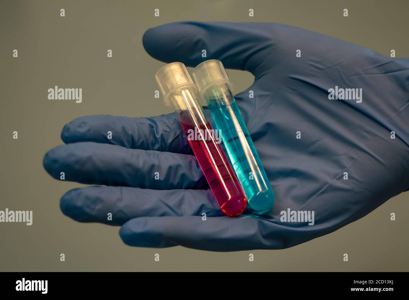 Hand holding tubes with colorful liquid Stock Photo - Alamy