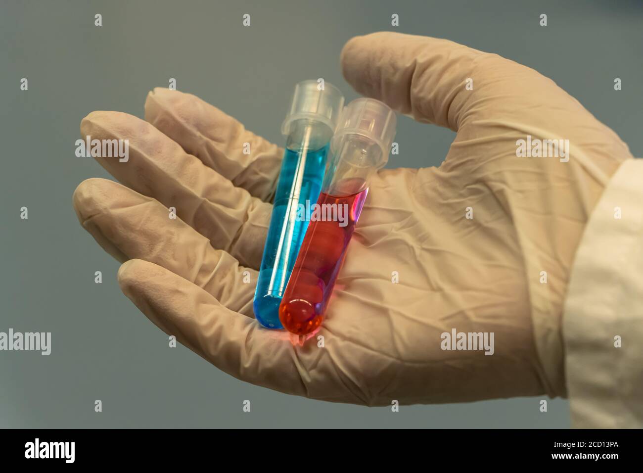 Hand holding tubes with colorful liquid Stock Photo - Alamy