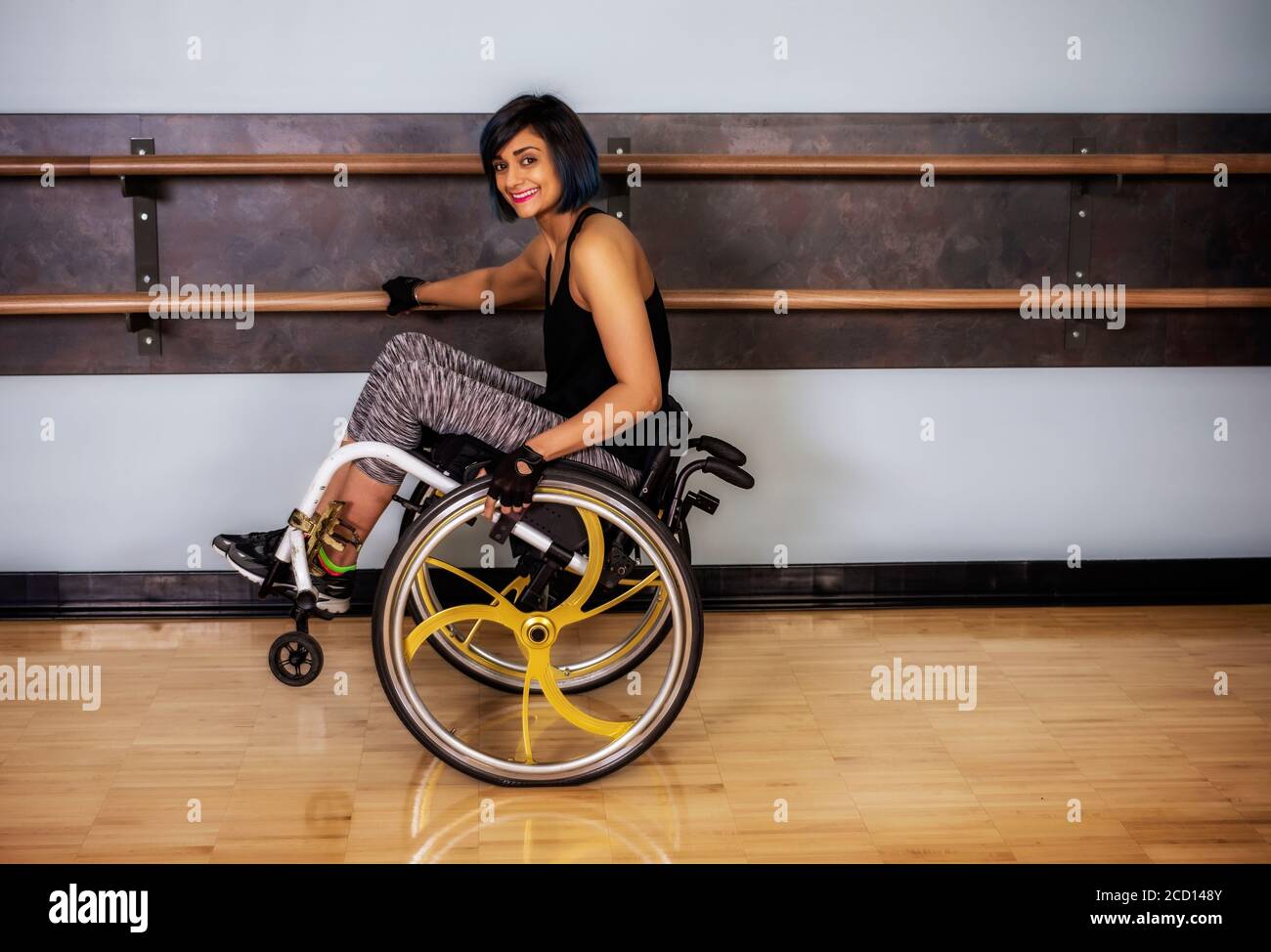 A paraplegic woman popping wheelie in her wheelchair and fooling around ...