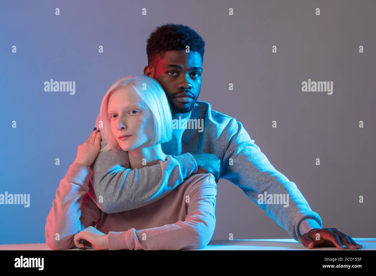 unhappy sad guy hugging the woman's neck and looking aside, isolated ...