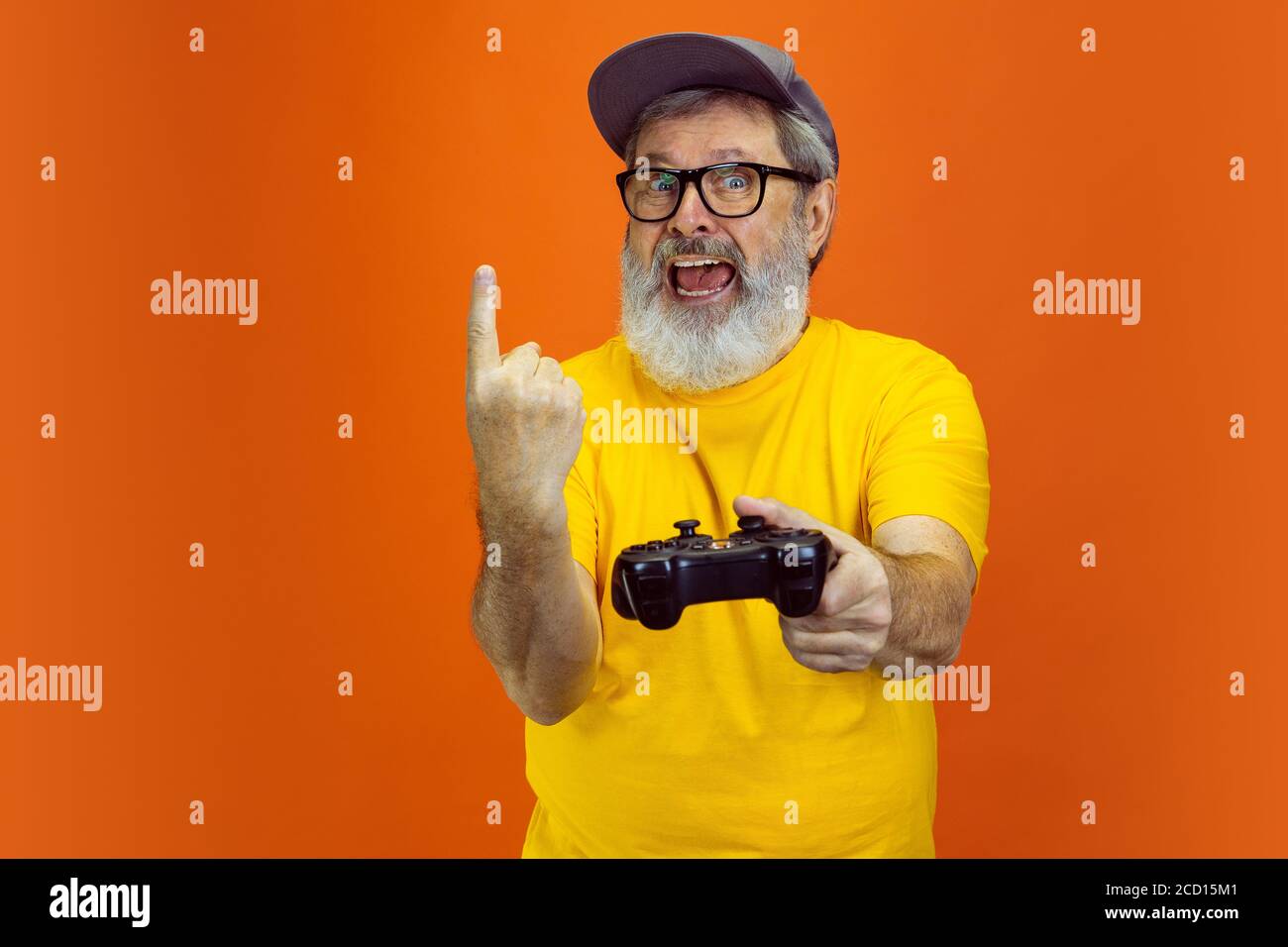 Tensioned gamer. Portrait of senior hipster man using devices, gadgets ...