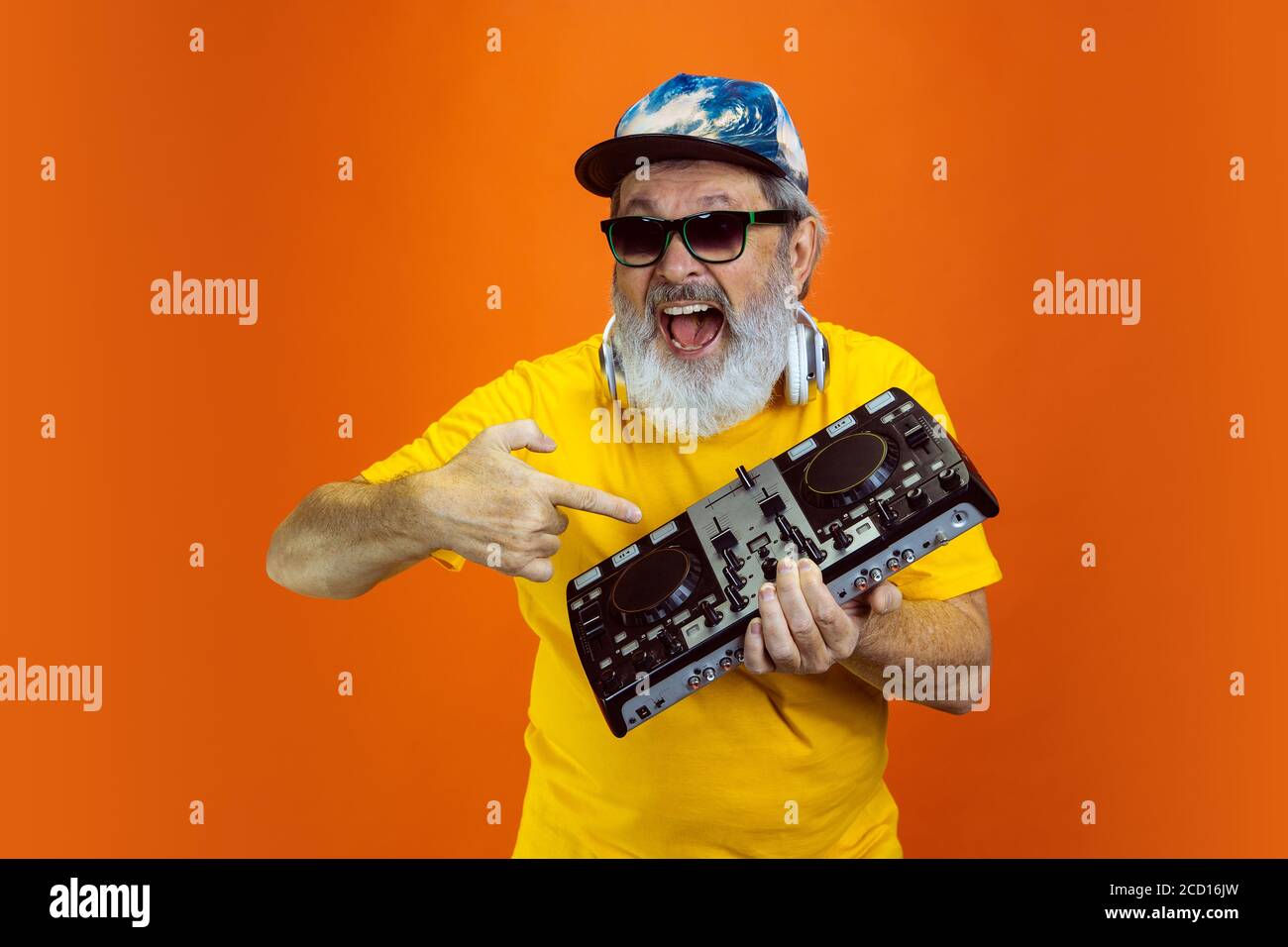 DJ-set. Portrait of senior hipster man using devices, gadgets isolated ...