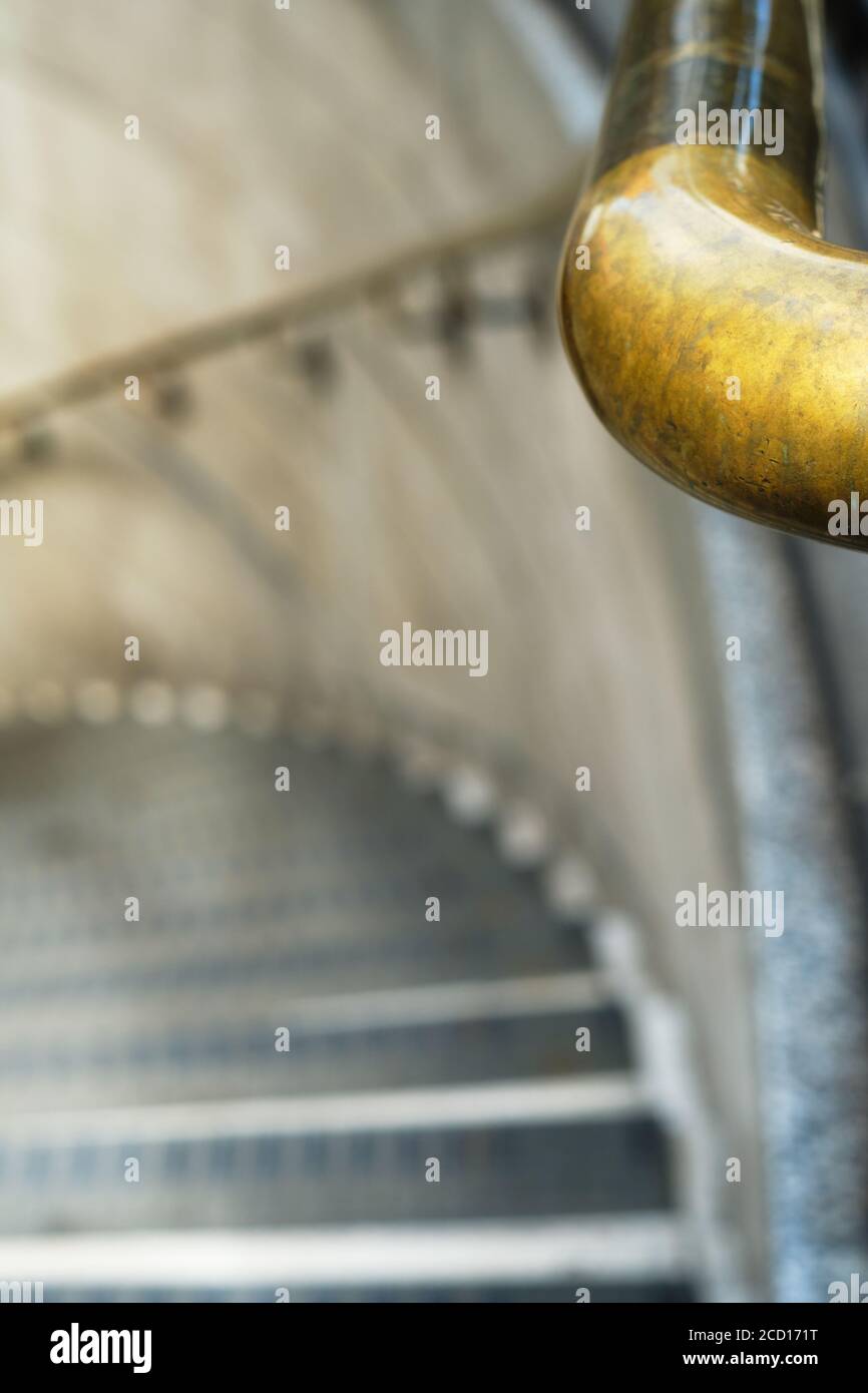 Perspective view of spiral stairs with gold handrail Stock Photo - Alamy