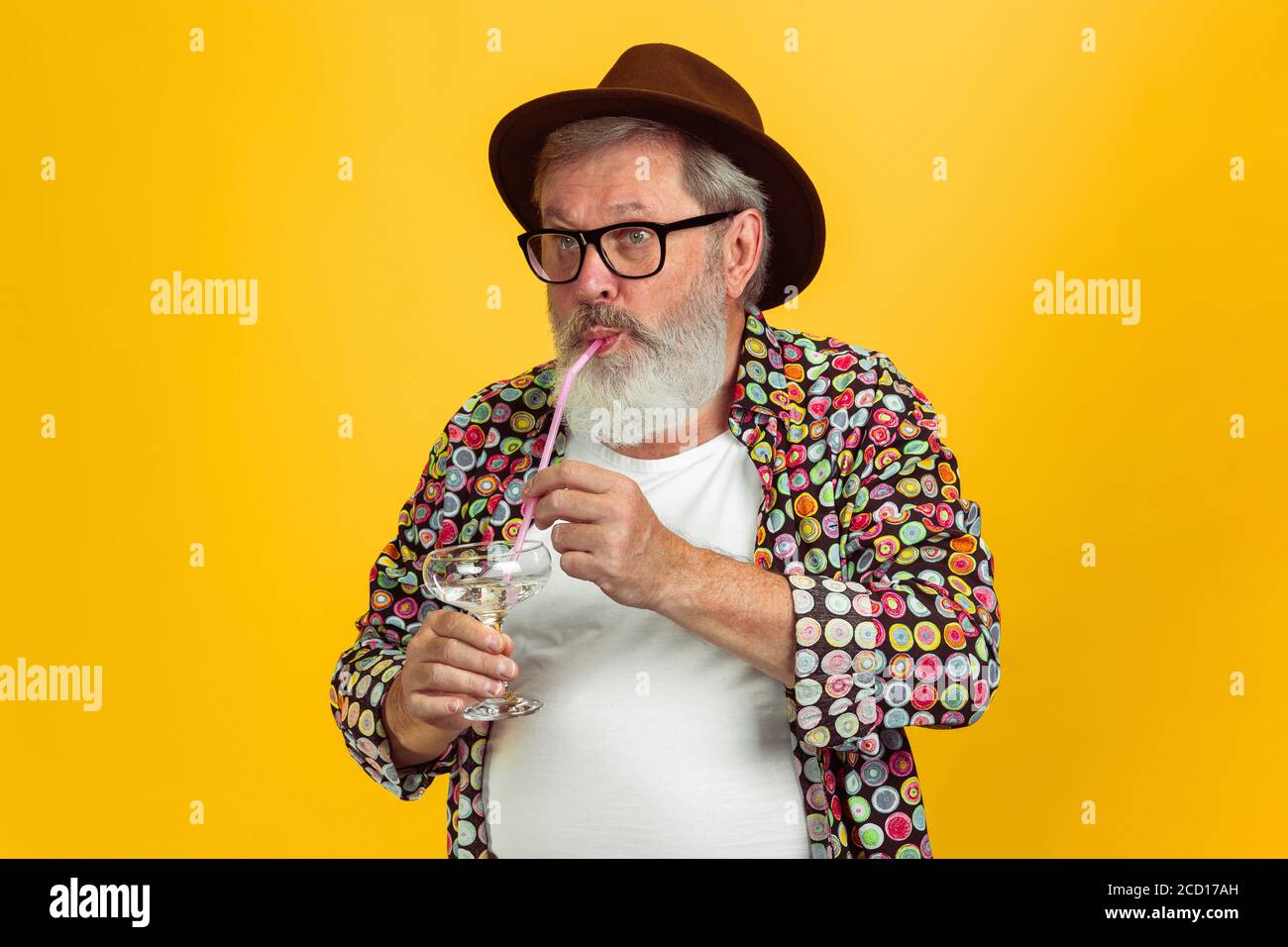 Time to drink. Portrait of senior hipster man in eyewear isolated on ...