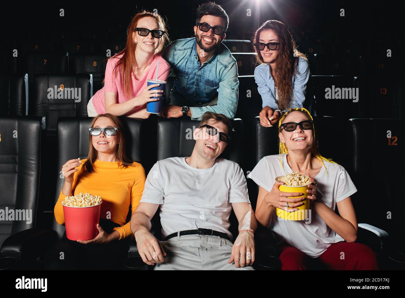 pleasant company enjoying day off at the cinema, students having movie ...