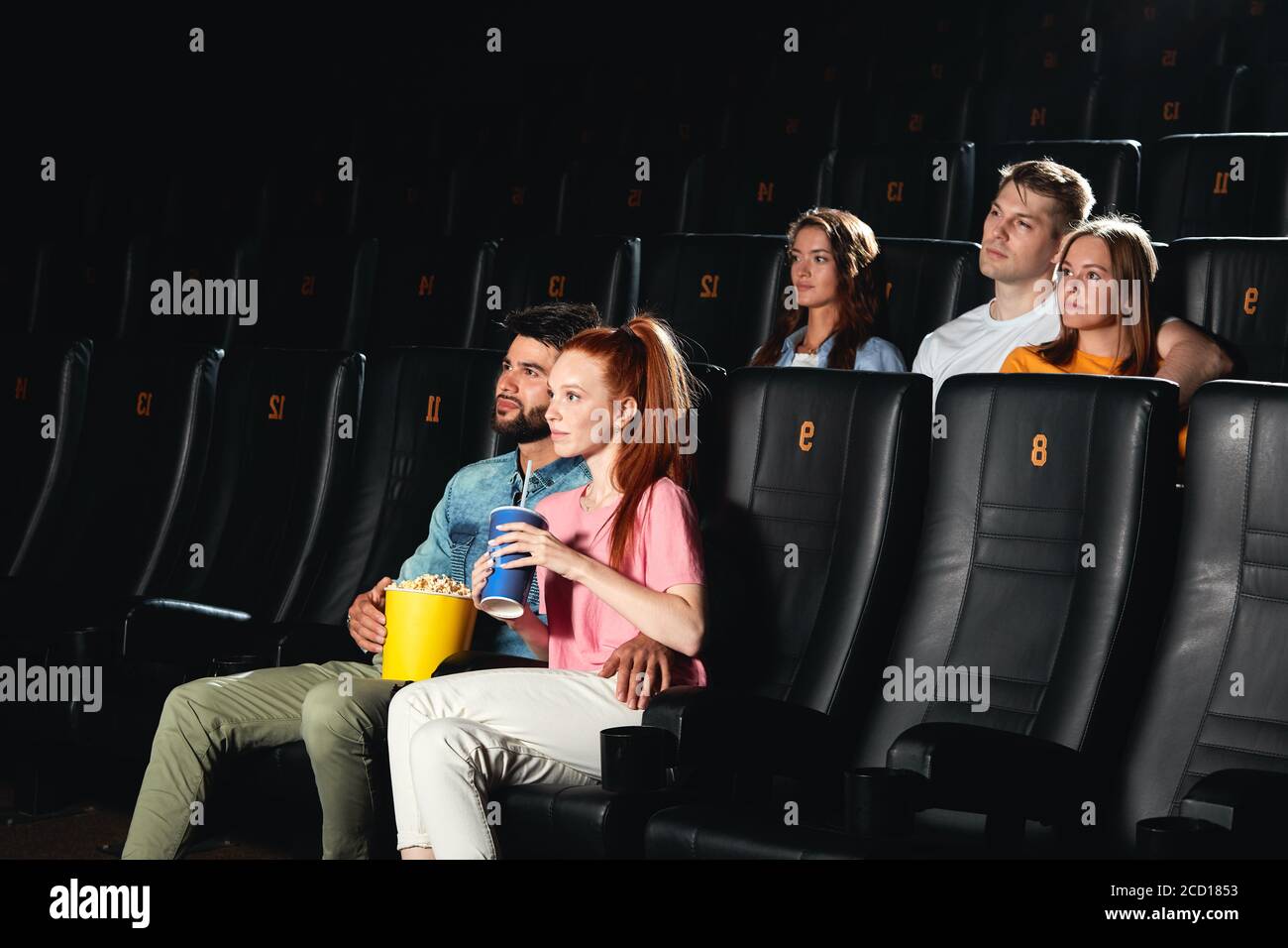 young people relaxing after difficult working day, they are watching a ...