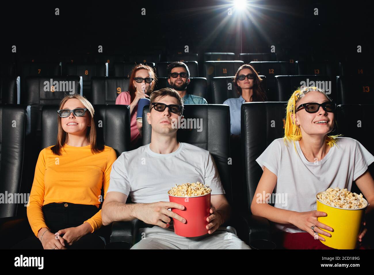 young people concentrated on watching their favourite film indoors ...