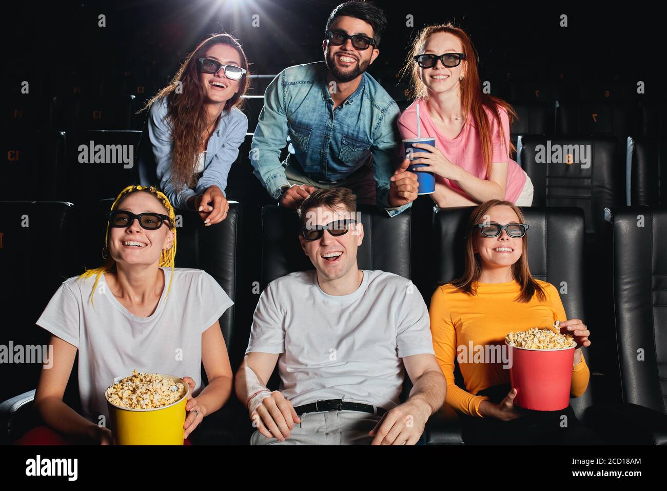 a group of friends having fun at the cinema, happiness, joy concept ...