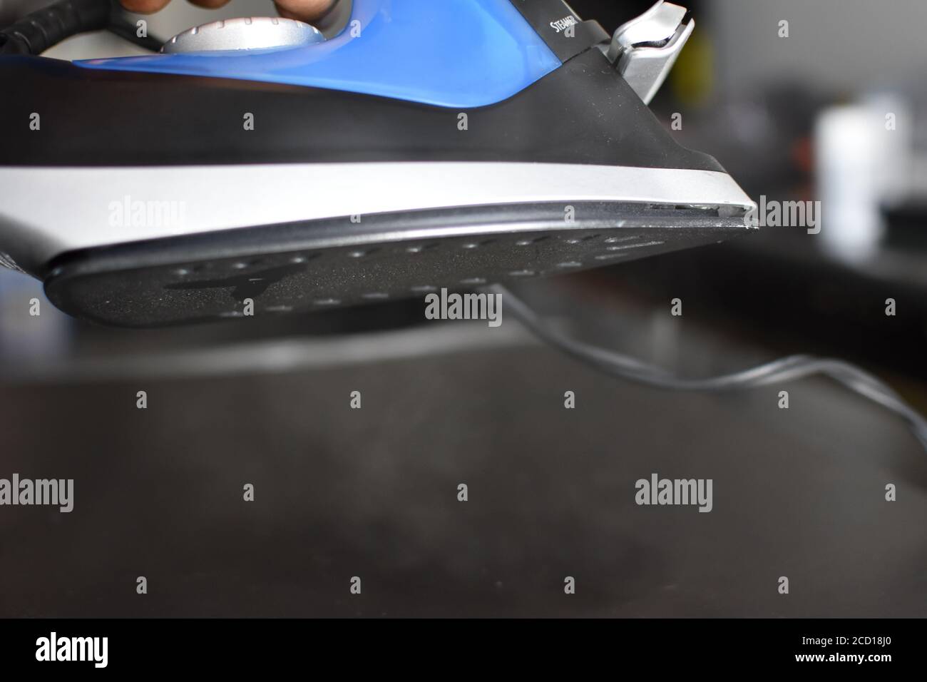 Iron box isolated against a blur background Stock Photo - Alamy