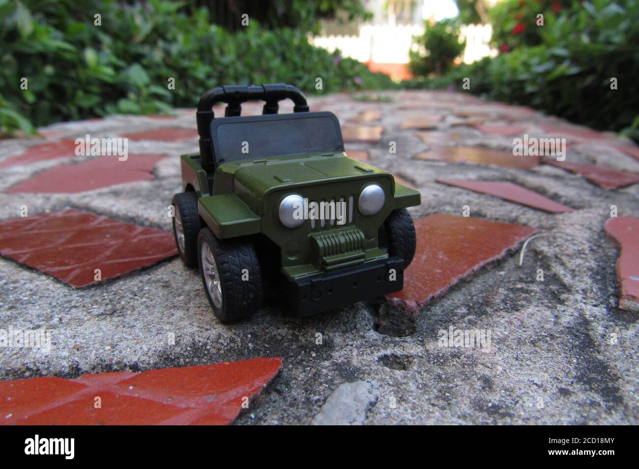Green toy car on the ground hi-res stock photography and images - Alamy