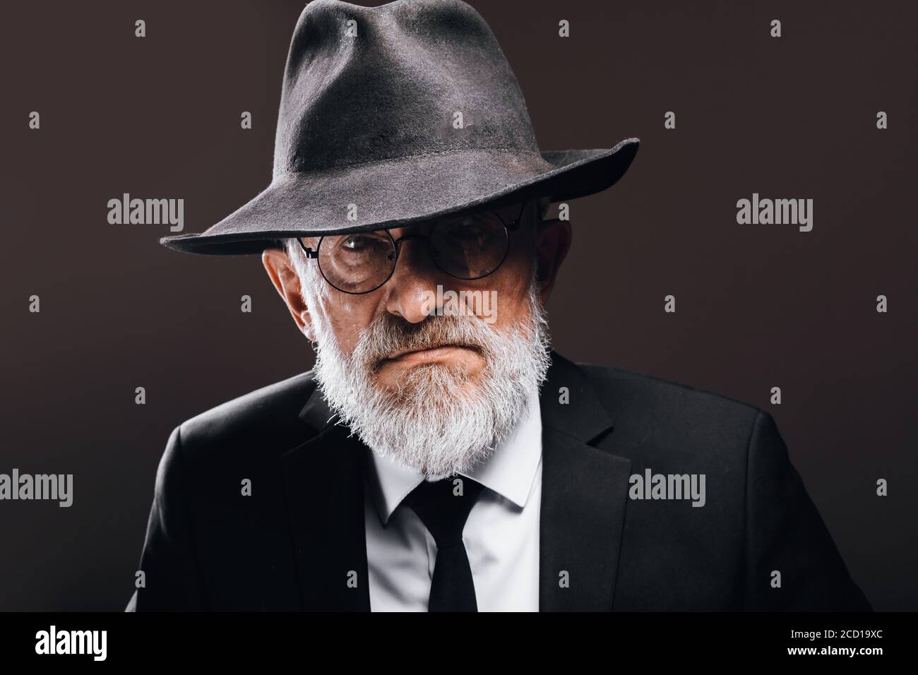 Old-aged bearded man in image of English secret agent wearing black ...
