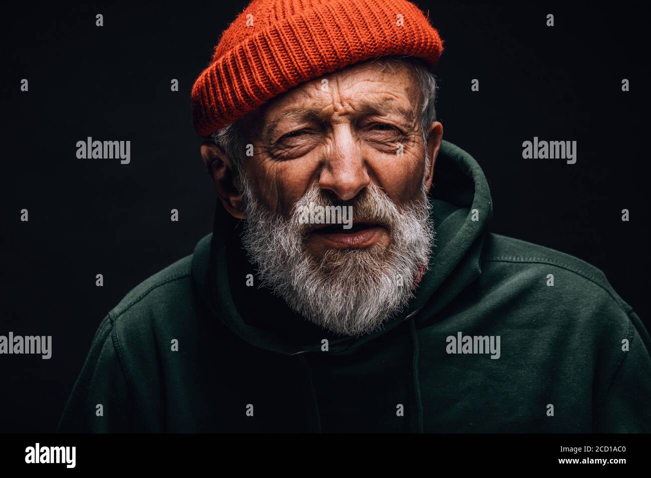 Old homeless man dressed in worn but clean outdoor clothes and hat ...