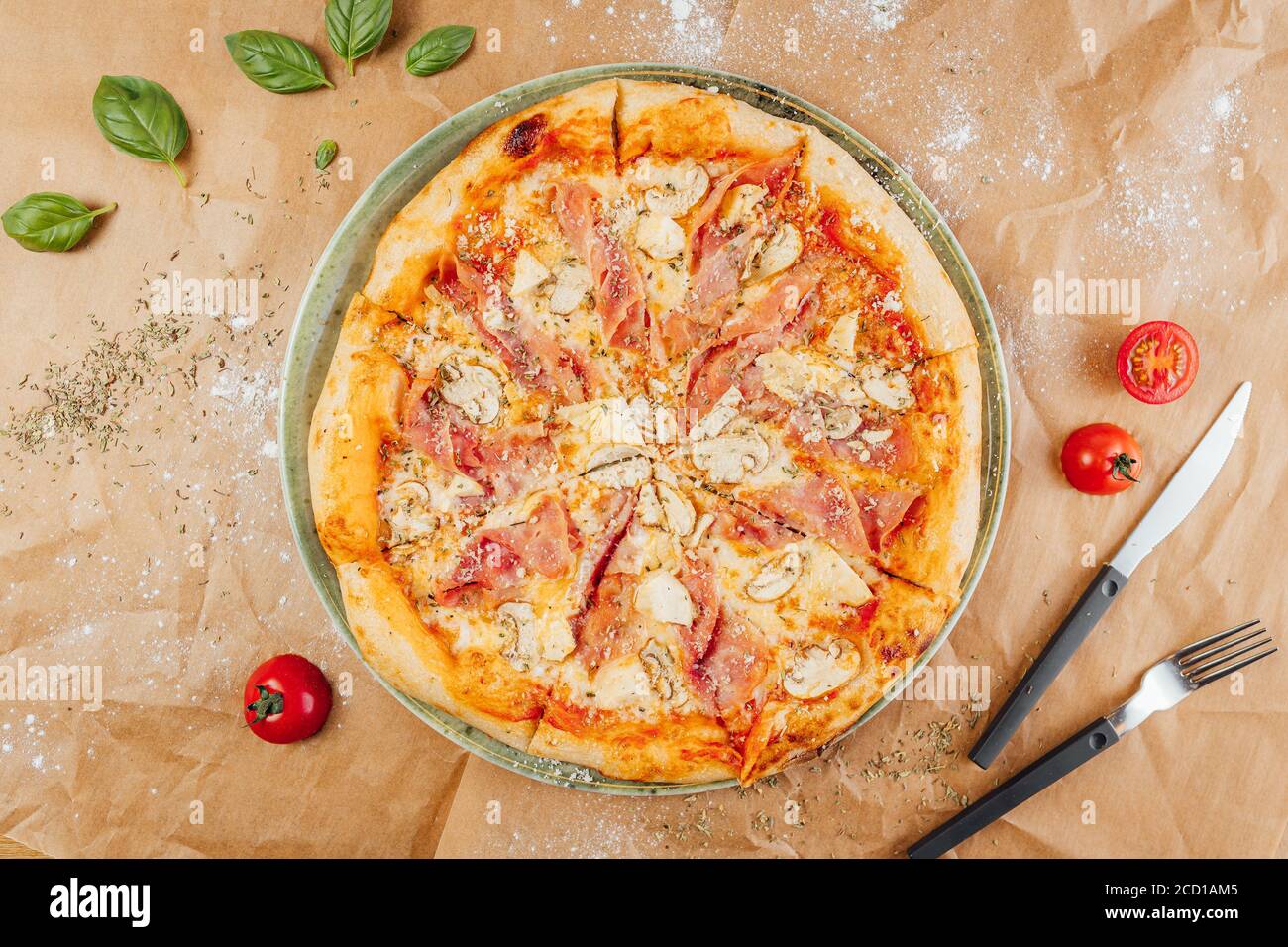 Flat lay of delicious pizza with fork and knife Stock Photo - Alamy