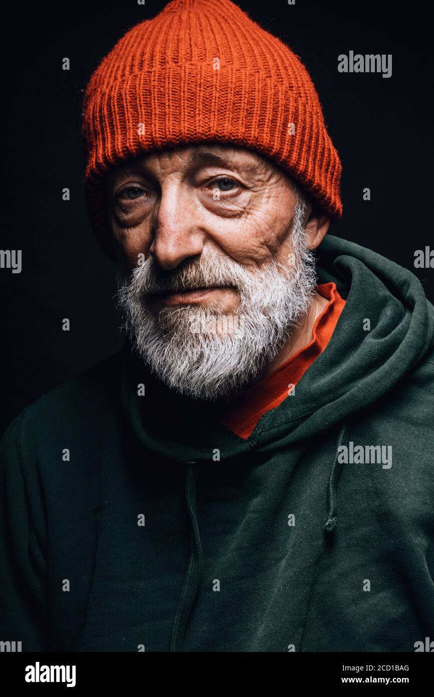 Serious senior grey-bearded fishman with wrinkled weathered face, puffy ...