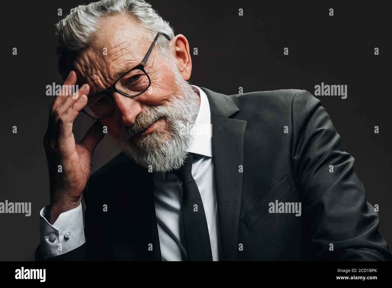 Confident serious senior male loyer in round spectacles and formal ...