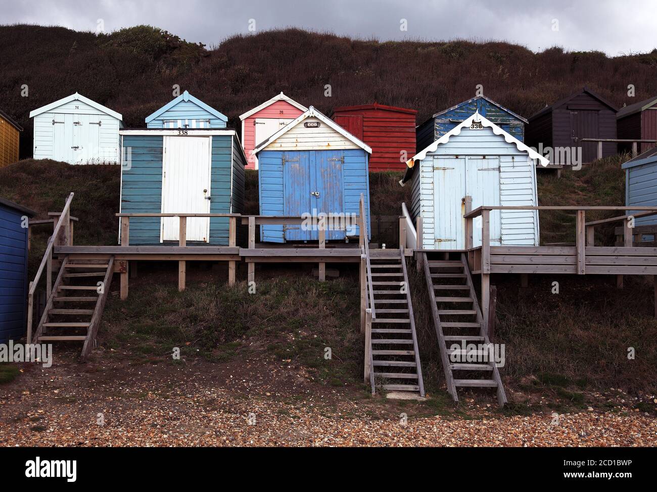 Old beach huts looking grim in bad weather Stock Photo - Alamy