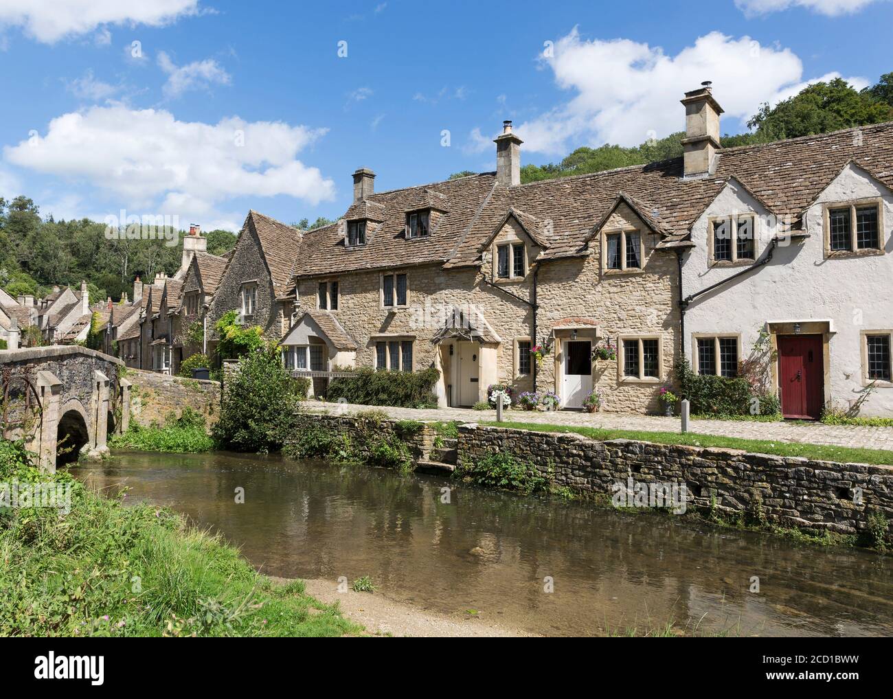 Old stone cottages and Bybrook River, “Castle Combe” village, Wiltshire ...