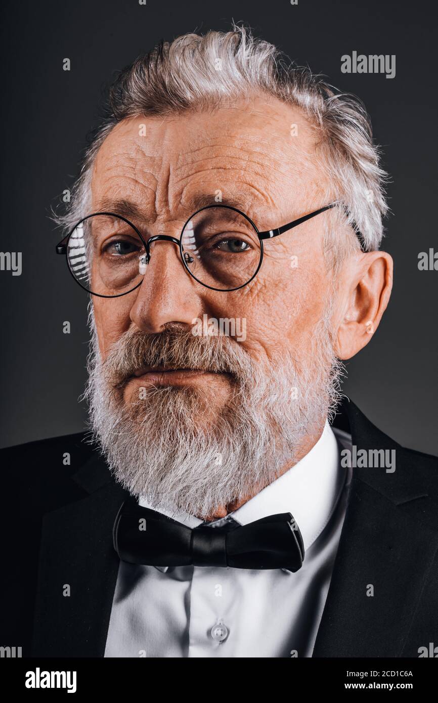 Closeup portrait of confident mature bearded dandy man in tuxedo with ...