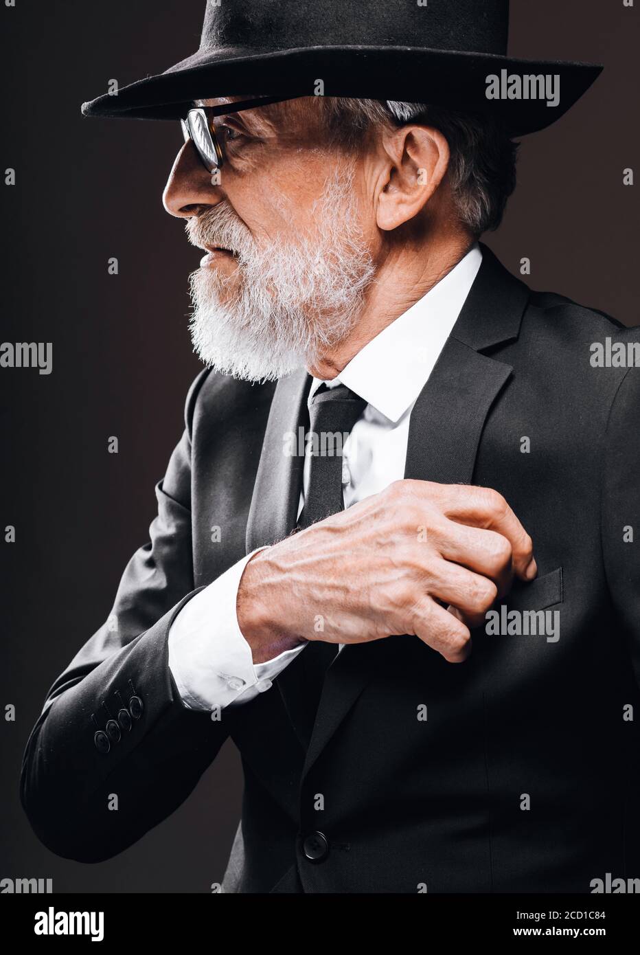 Old-aged bearded man in image of English secret agent wearing black ...