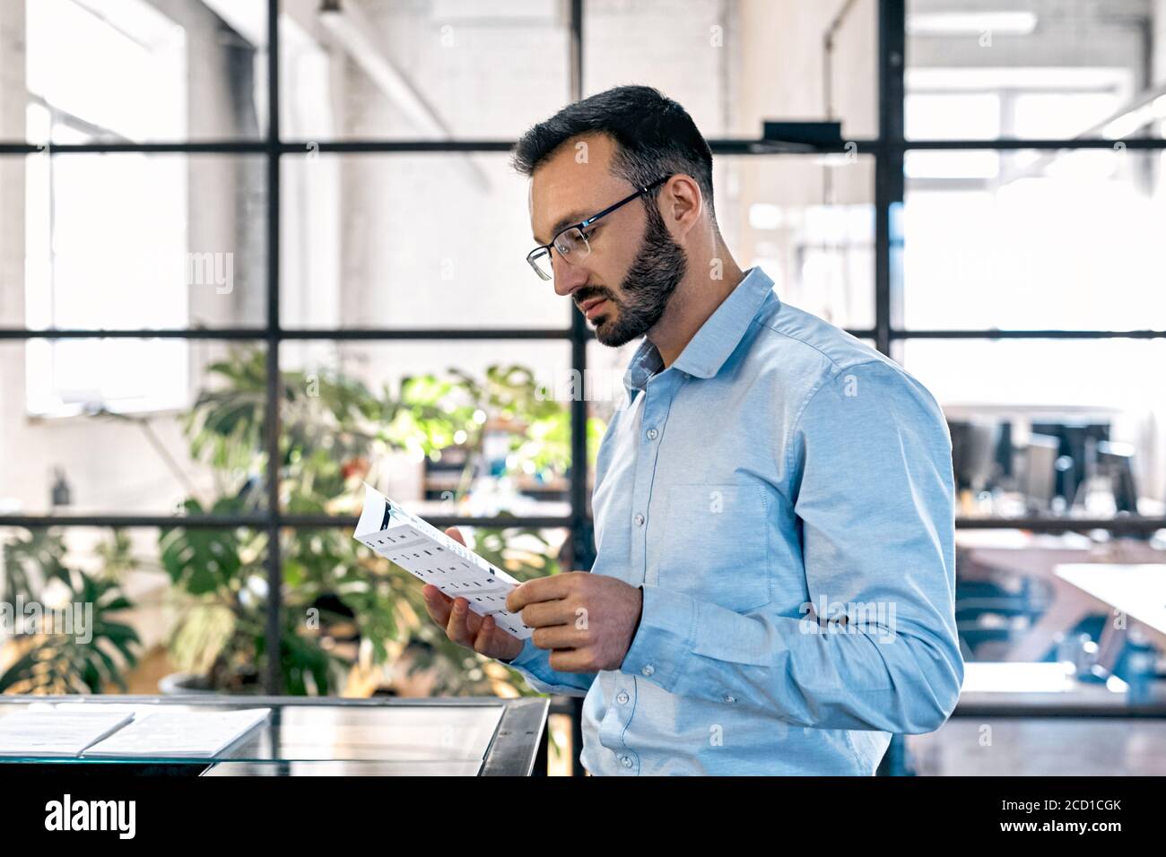 Focused employee reading document hi-res stock photography and images ...