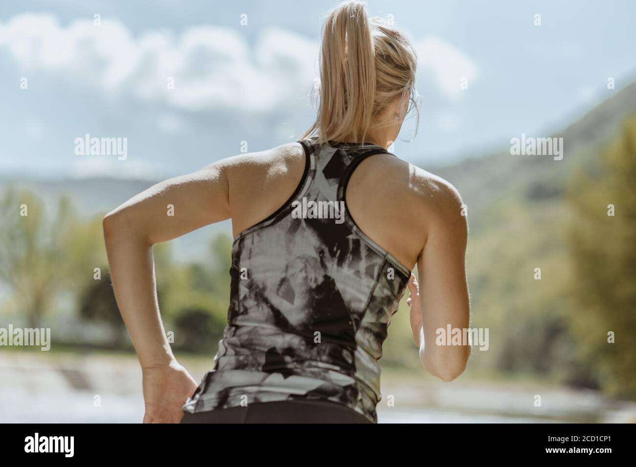 Back view photo of young blonde girl wearing sportswear running in the ...