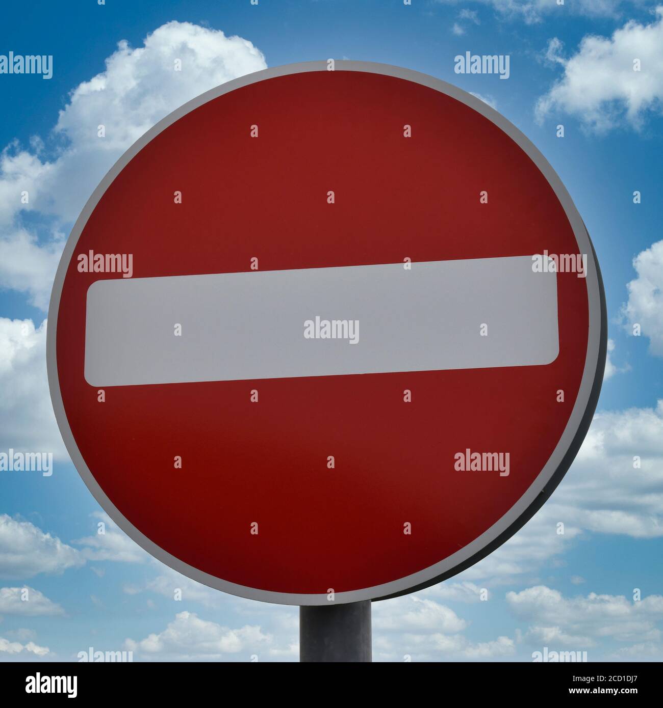 Isolated red and white circular no entry road sign in UK with blue sky ...