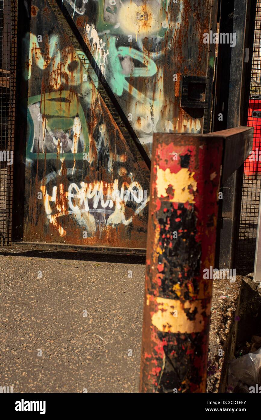 Abstract of colourful pole in front of equally colourful abstract wall ...