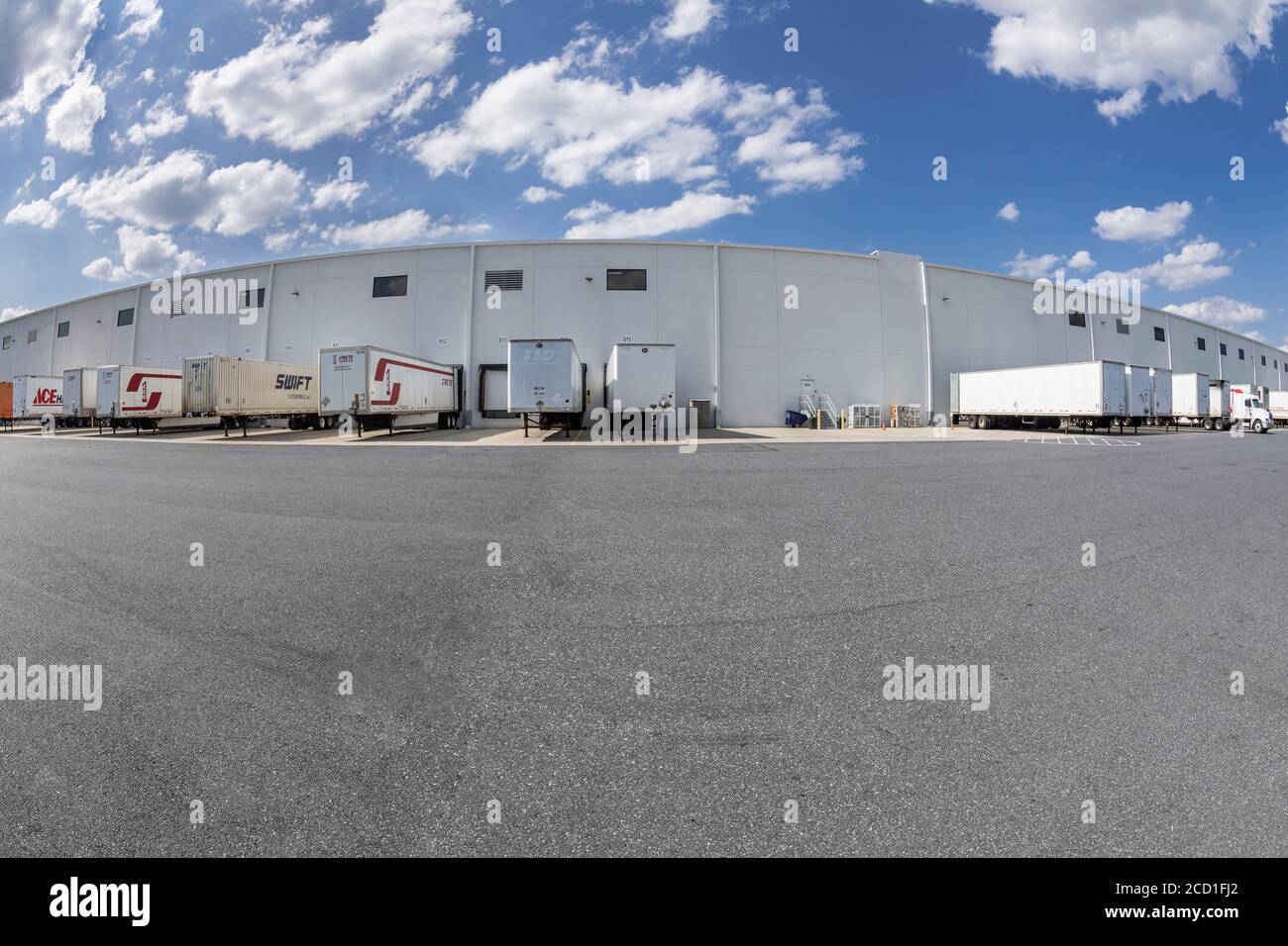 Warehouse loading docks with trucks Stock Photo - Alamy