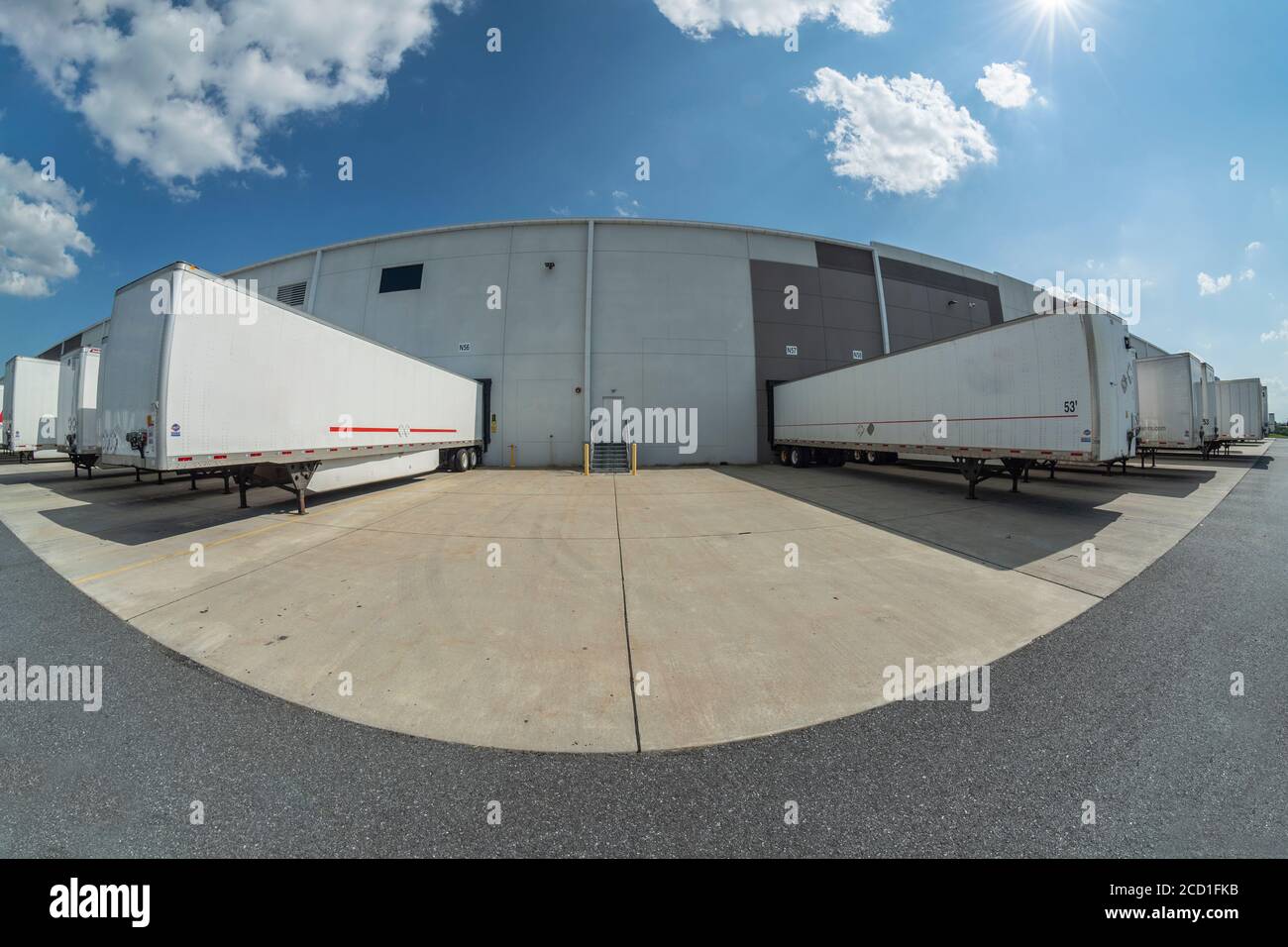Warehouse loading docks with trucks Stock Photo - Alamy