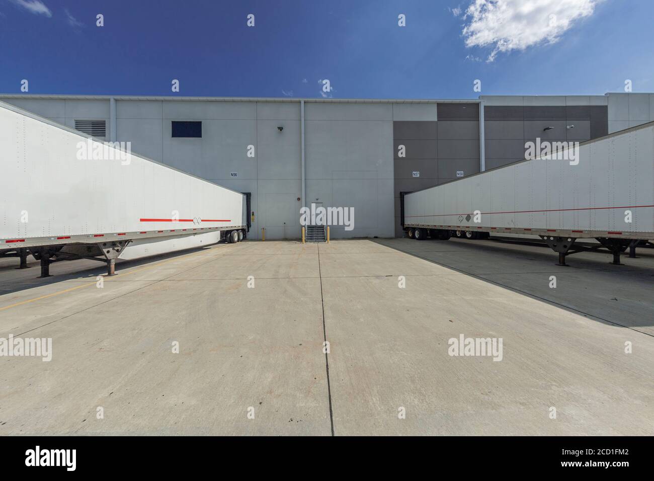 Warehouse loading docks with trucks Stock Photo - Alamy