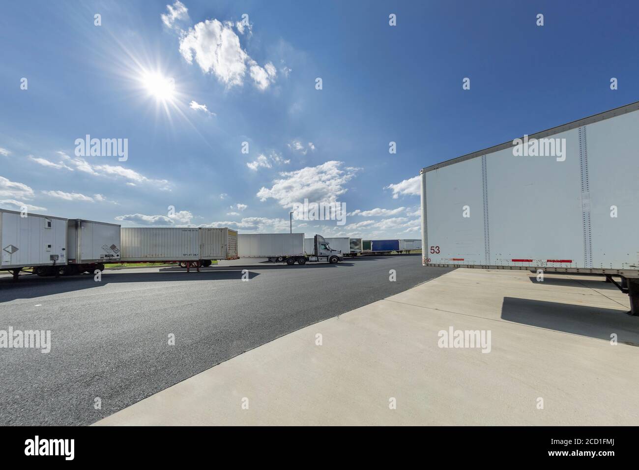 Warehouse loading docks with trucks Stock Photo - Alamy