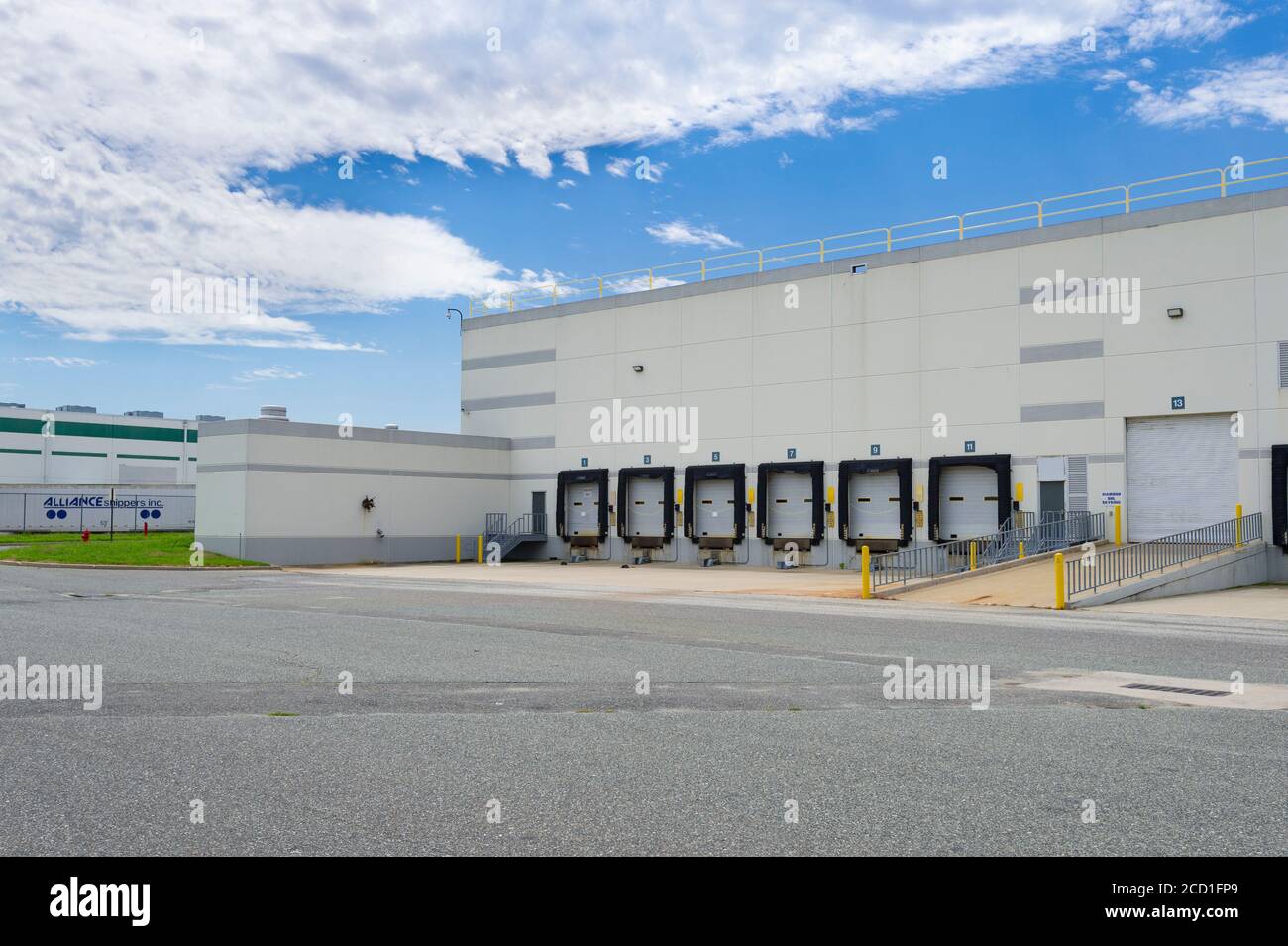 Warehouse loading docks with trucks Stock Photo - Alamy