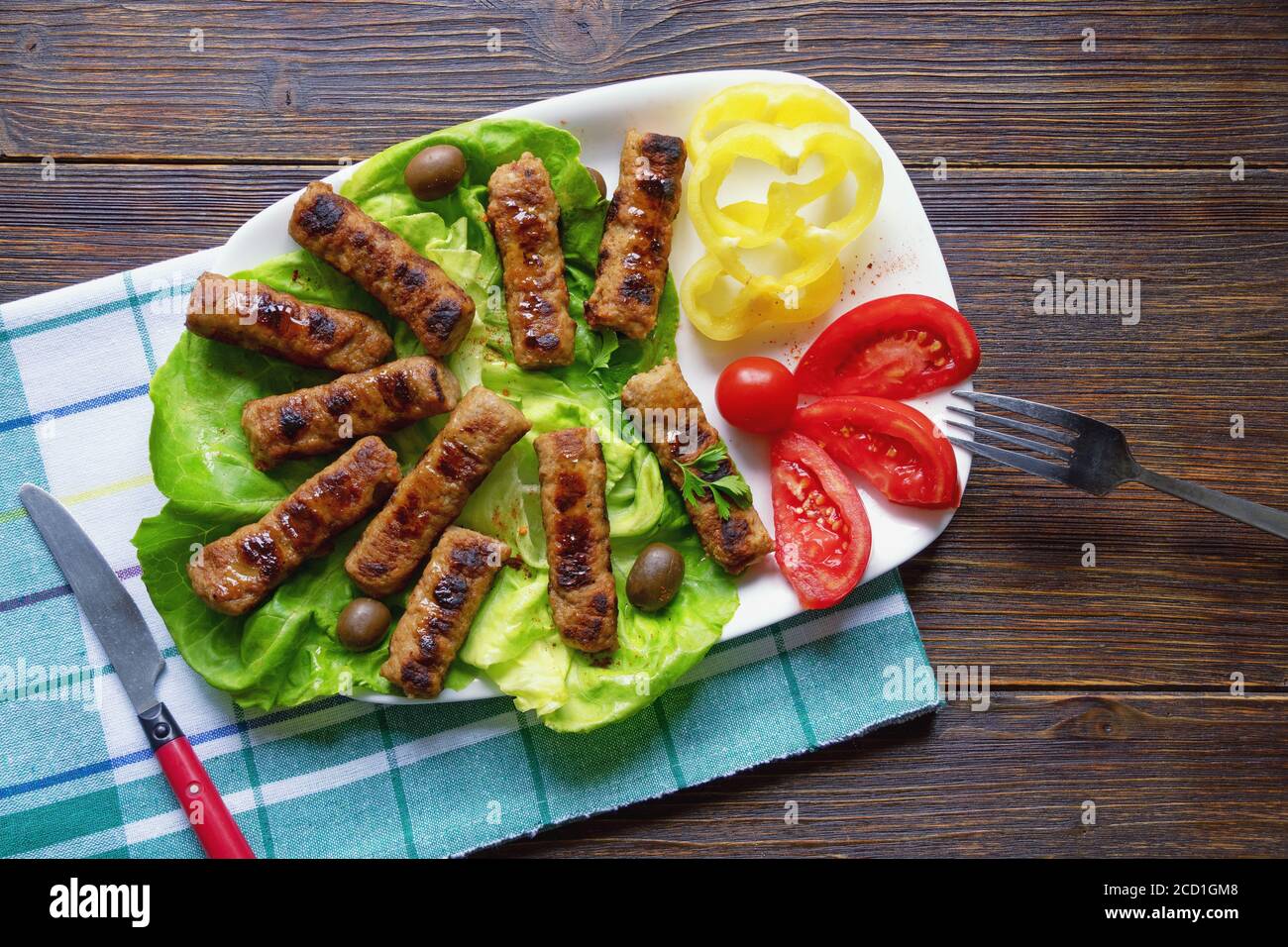 Balkan cuisine. Cevapi - grilled dish of minced meat. Flat lay, copy ...