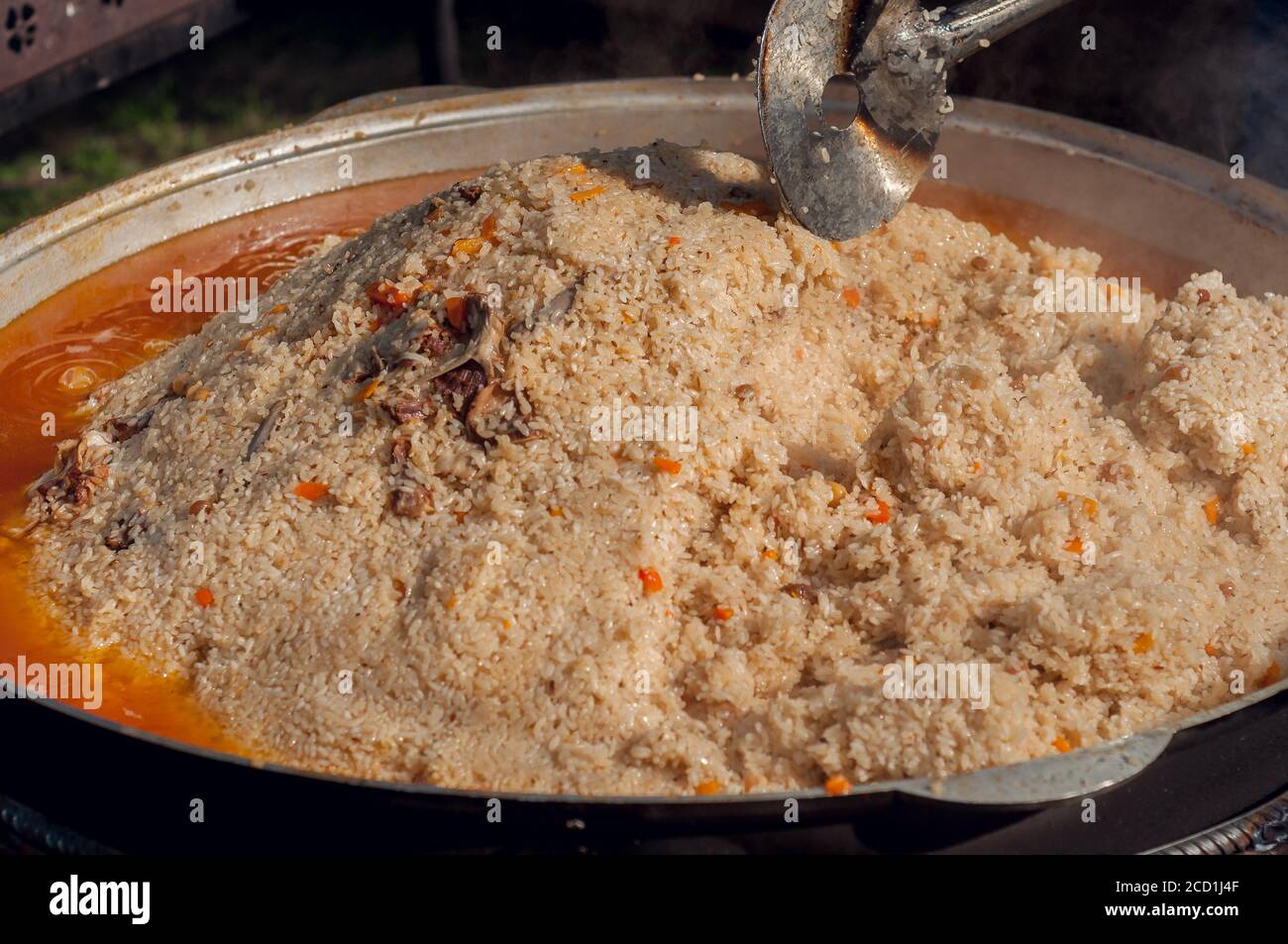 National food of the eastern peoples. Pilaf in a large cauldron. Rice ...