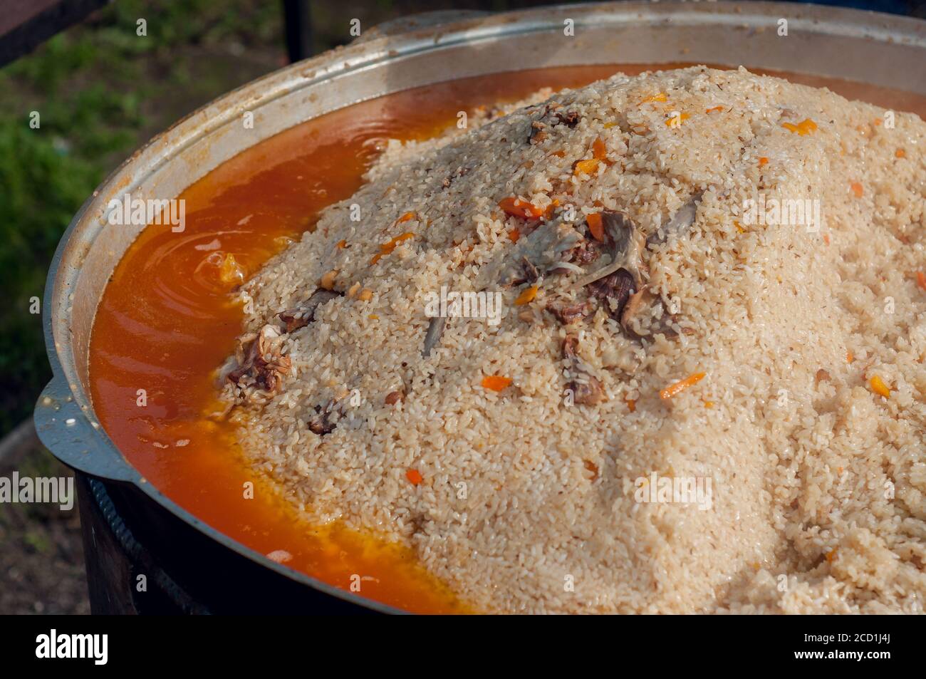 National food of the eastern peoples. Pilaf in a large cauldron. Rice ...