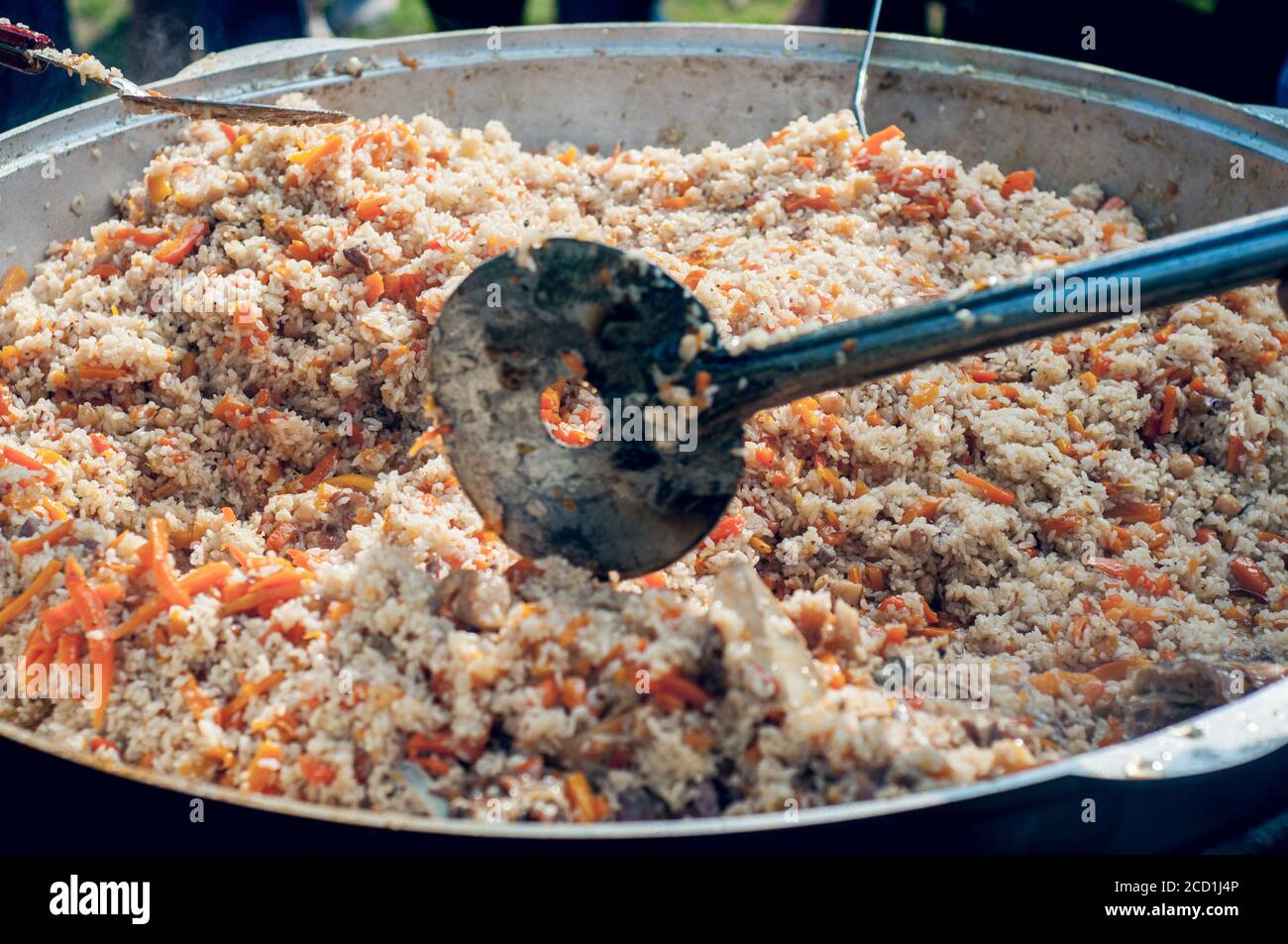 National food of the eastern peoples. Pilaf in a large cauldron. Rice ...