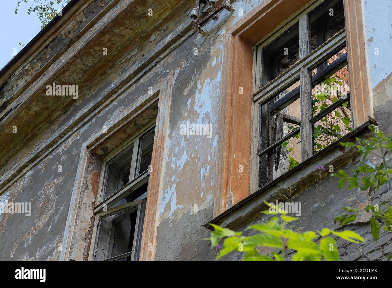 Detail of an old abandoned house. Moisture-damaged plaster. Old shabby ...