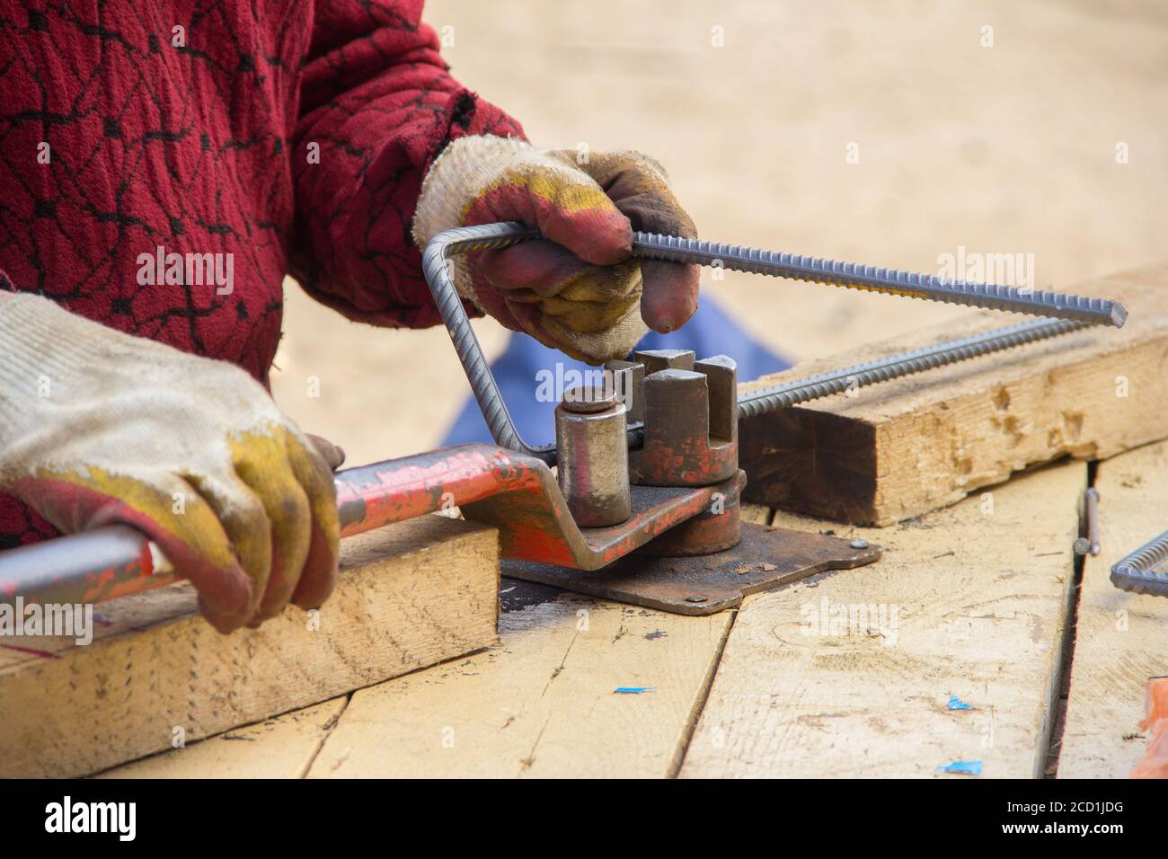 Bending reinforcement metal rebar. Worker using bending rebar machine ...