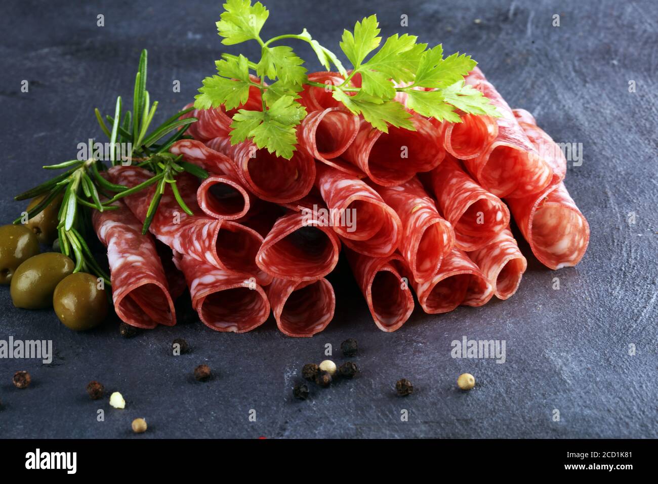 thinly sliced salami. delicious snack rustic salami Stock Photo - Alamy