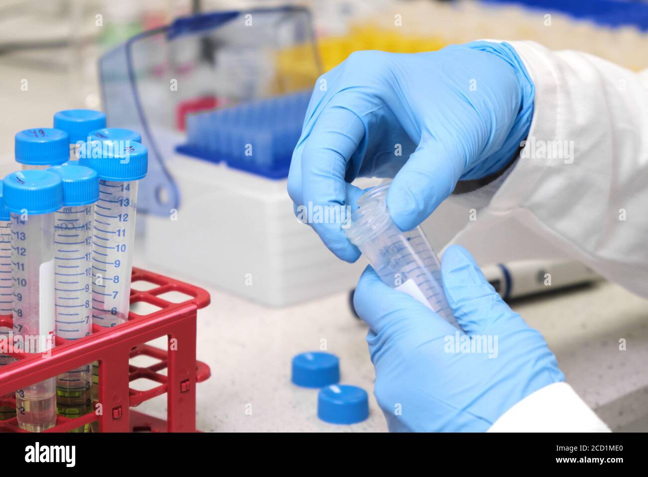 Sample preparation process by analytical chemist. Close up womans hand taking falcone tube and ...
