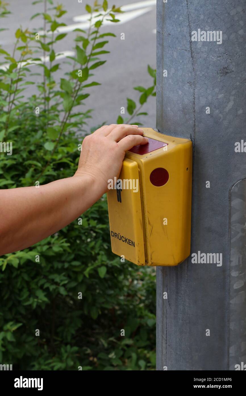 Pedestrian presses the traffic light on the transition Stock Photo - Alamy