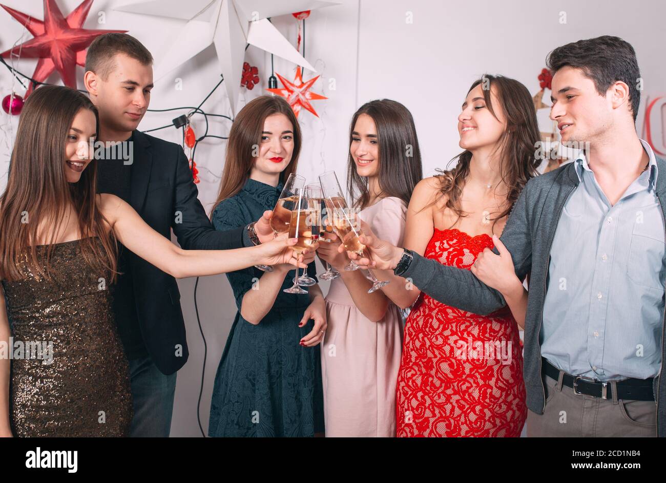 Portrait of several friends celebrating Christmas party Stock Photo - Alamy