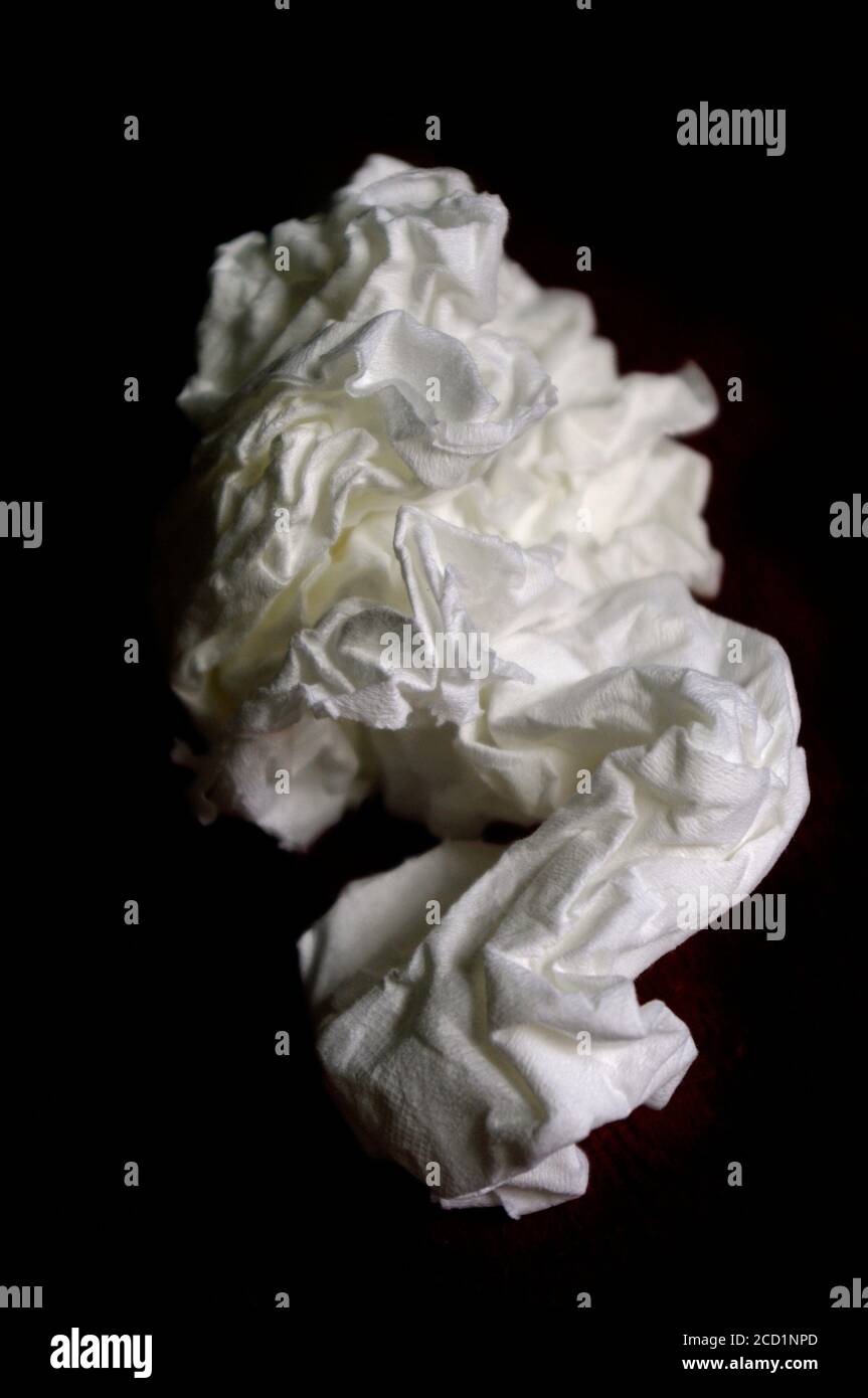 Crumpled white tissue on a black background Stock Photo - Alamy