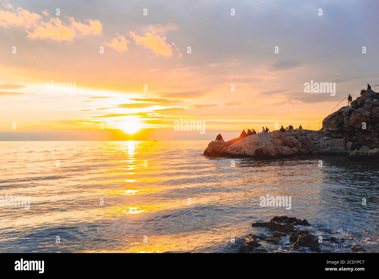 people resting at the beach of the sea enjoying view of sunset Stock ...