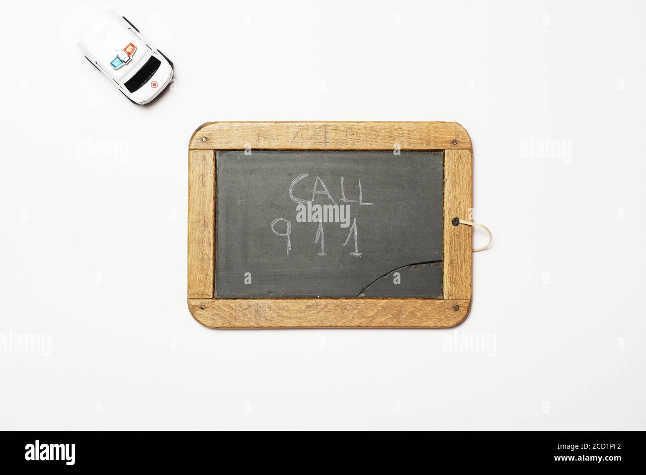 blackboard with call 911 message and toy ambulance next to it ...