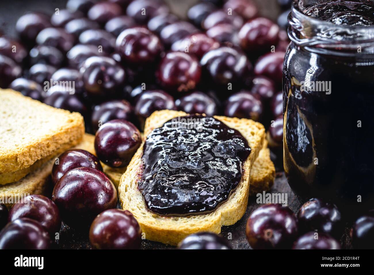 toast with grape jam, on rustic wooden table. Jabuticaba, exotic ...