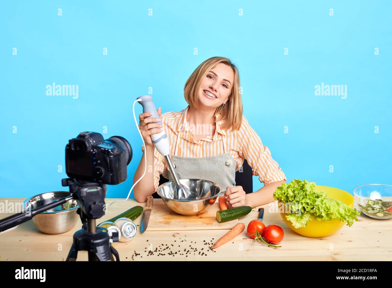 Joyful attractive housewife broadcasting video for her personal account ...