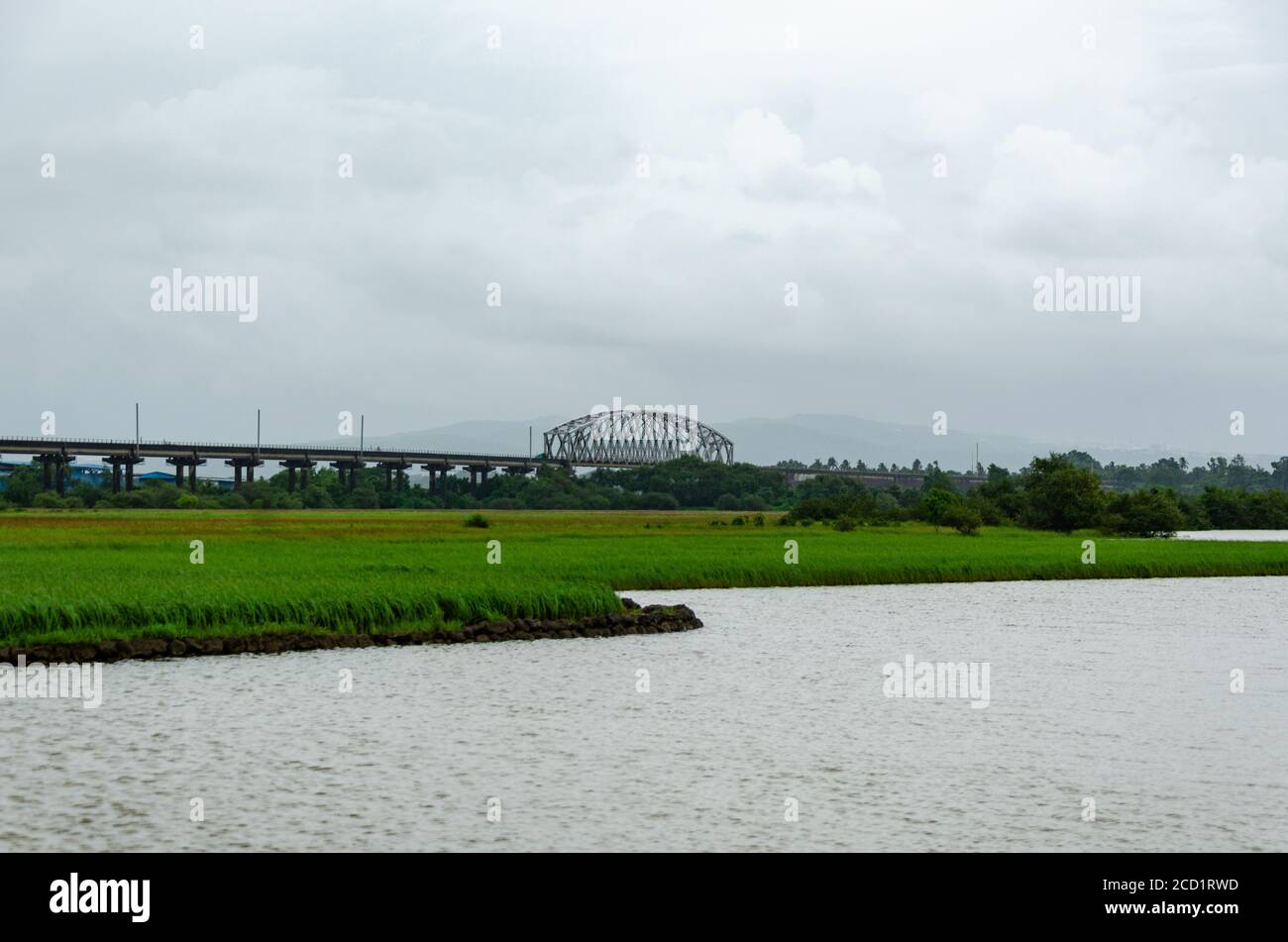 View of the Konkan Railway bridge and lush green fields at Divar Island ...