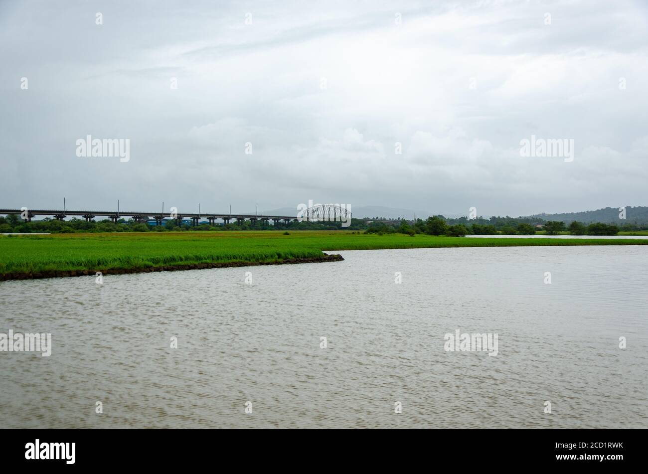 View of the Konkan Railway bridge and lush green fields at Divar Island ...